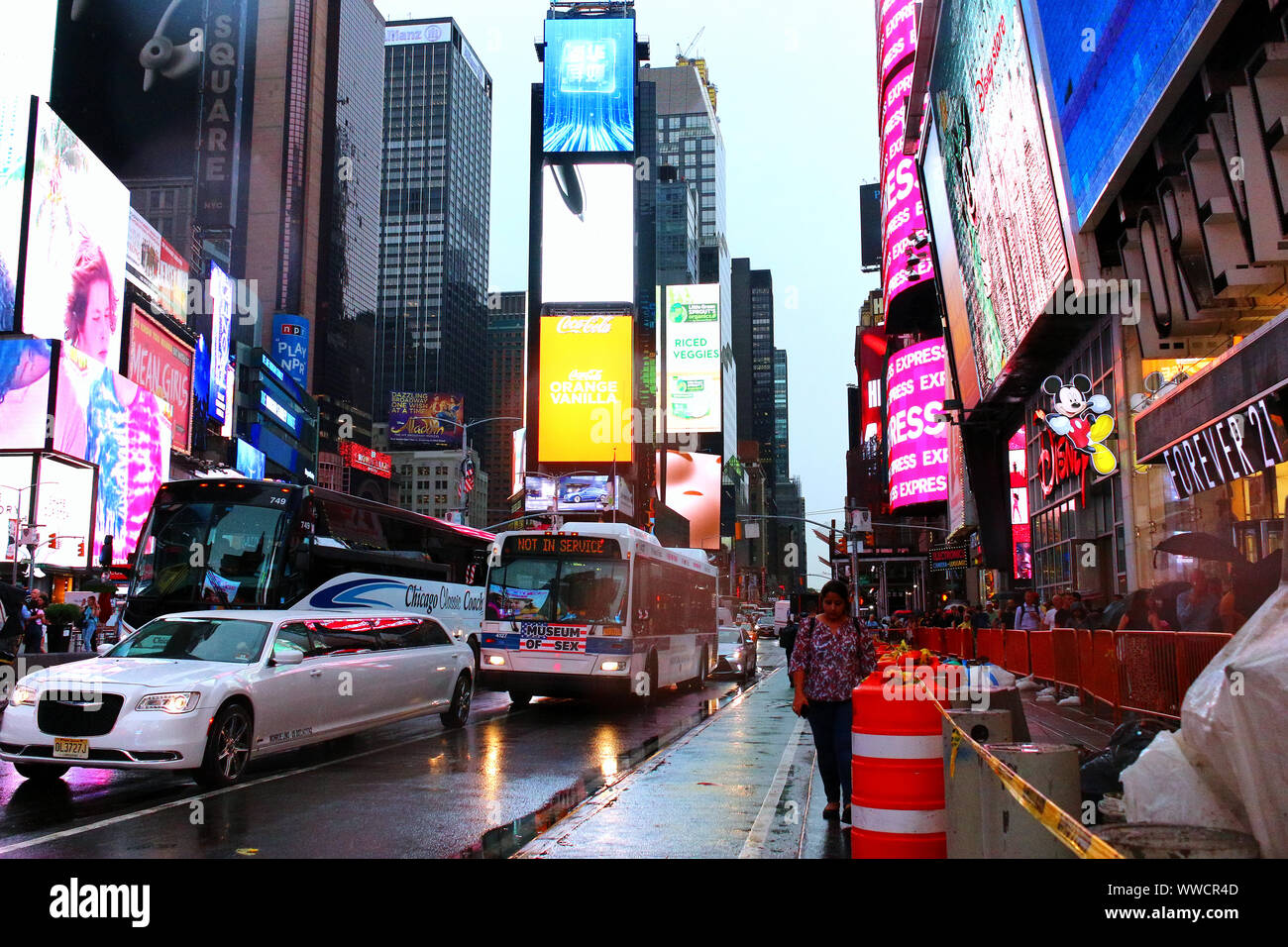Traffic of pedestrians, cyclists, and cars trudges through Times Square ...