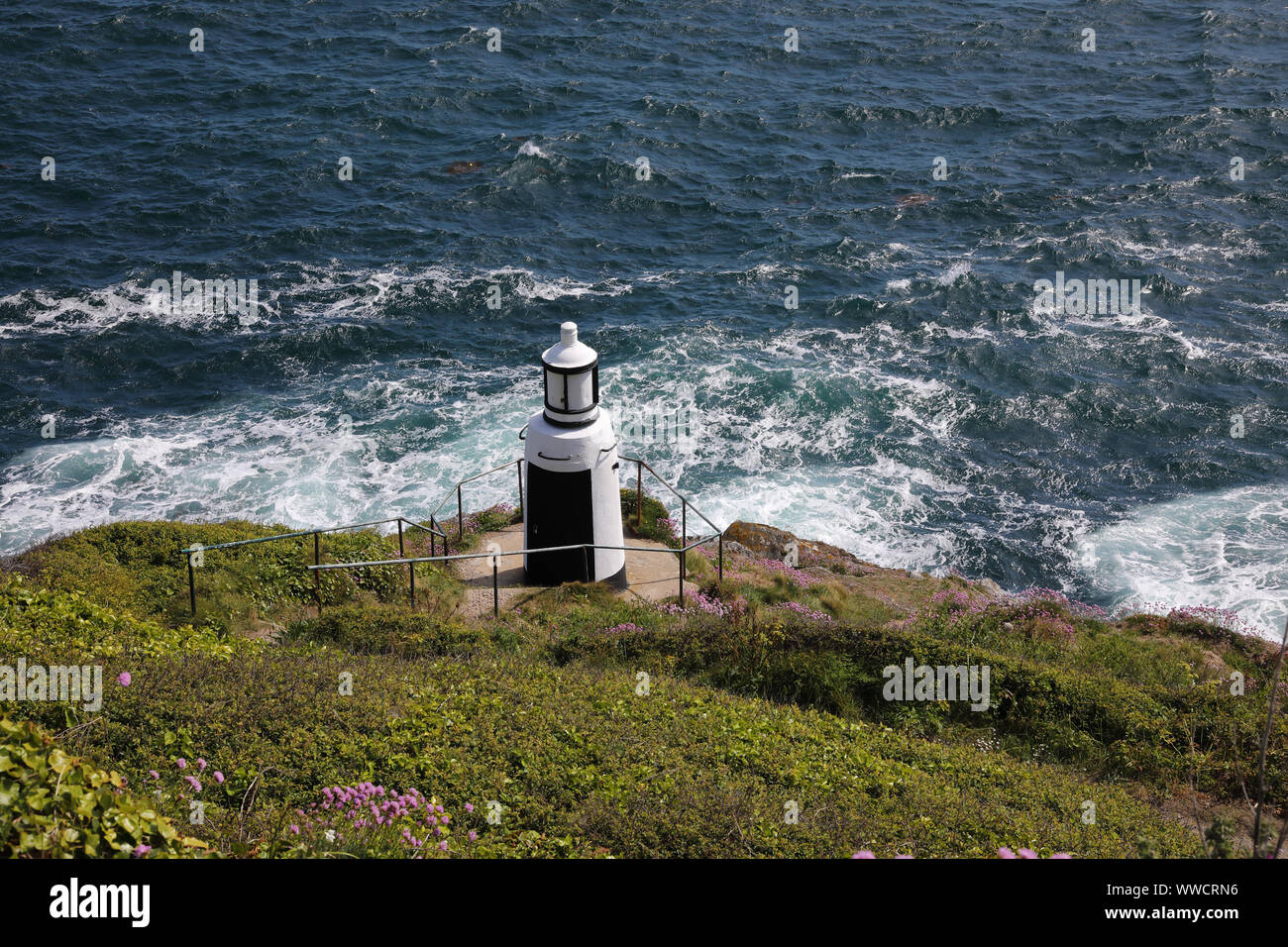 Spy House point lighthouse , Polperro Cornwall Stock Photo - Alamy