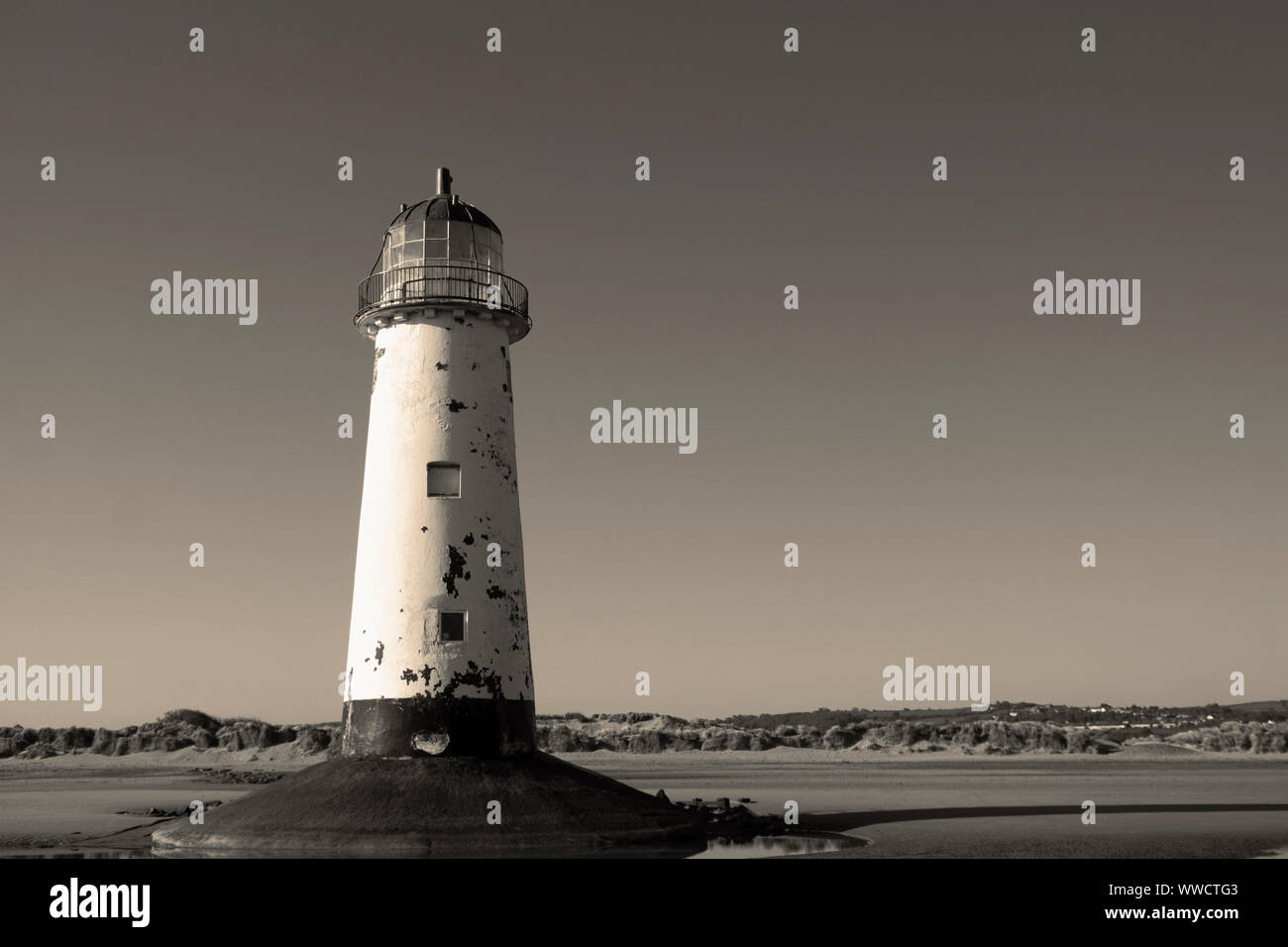 Point of Ayr lighthouse on a beach in North Wales. With sepia colour ...