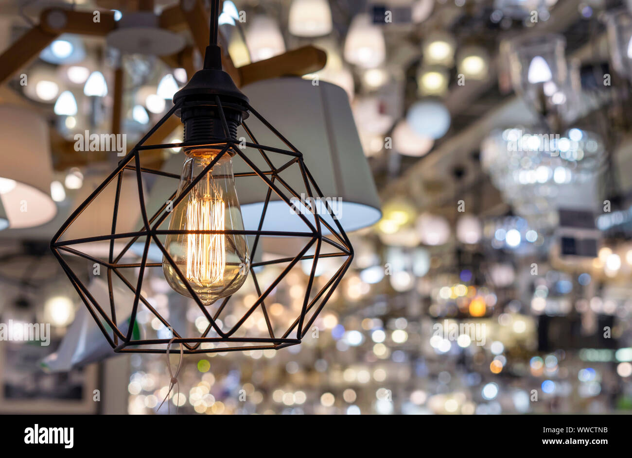 Lamp of style of the loft in an interior of shop. A stylish lamp in a ...