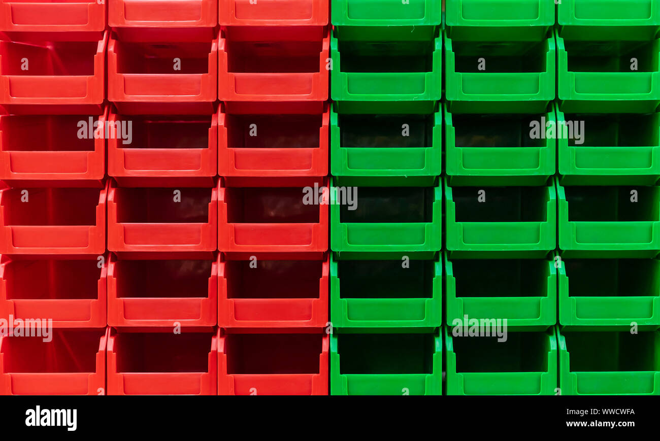 Plastic green and red containers are stacked in several rows Stock ...