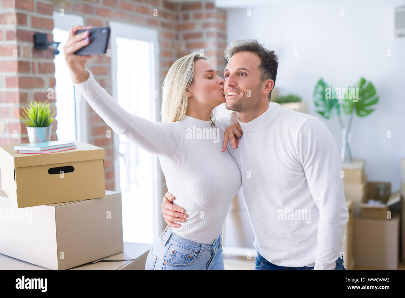 Young Beautiful Couple Standing Using Smartphone To Take Selfie Kissing