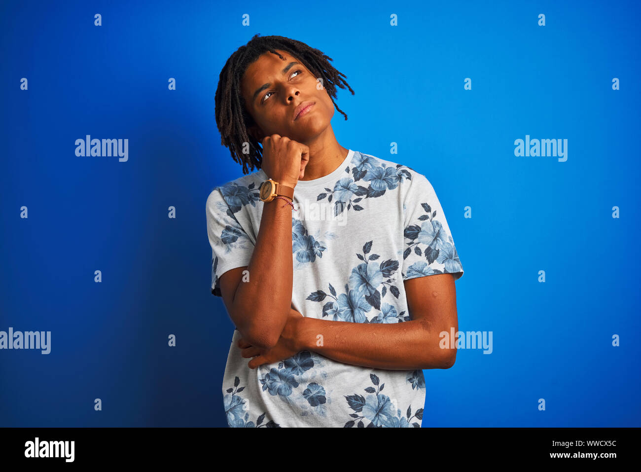Afro american man with dreadlocks wearing summer floral t-shirt over ...