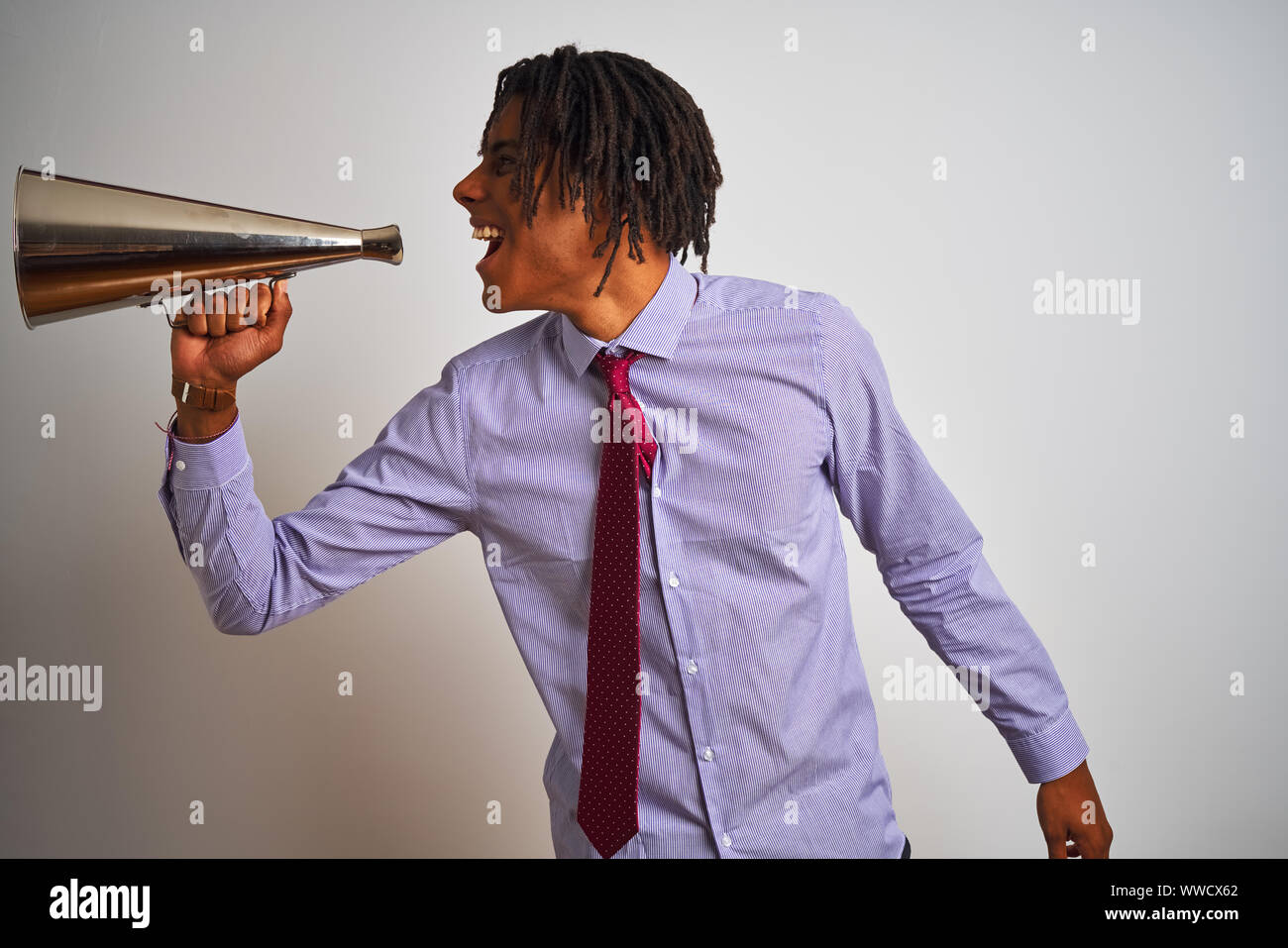 Young african american businessman screaming using vintage megaphone ...