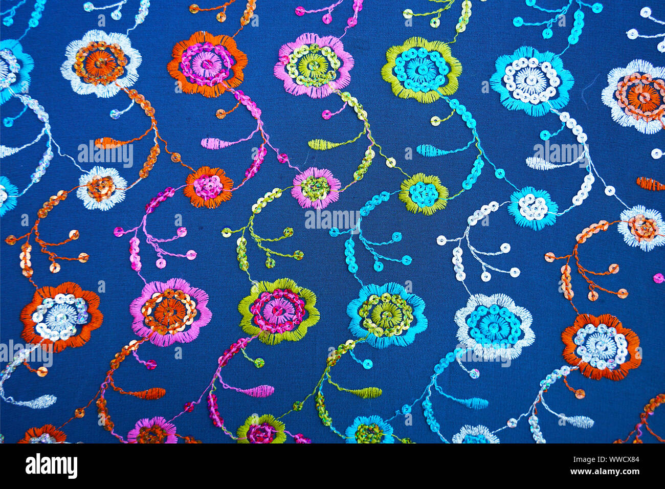 Blue fabric texture with floral embroidery and sequins Stock Photo - Alamy