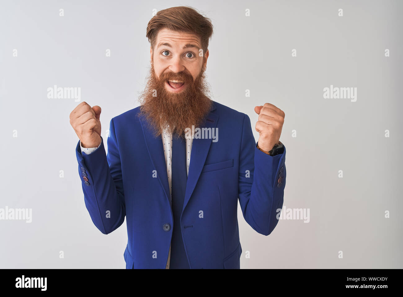 Young redhead irish businessman wearing suit standing over isolated ...