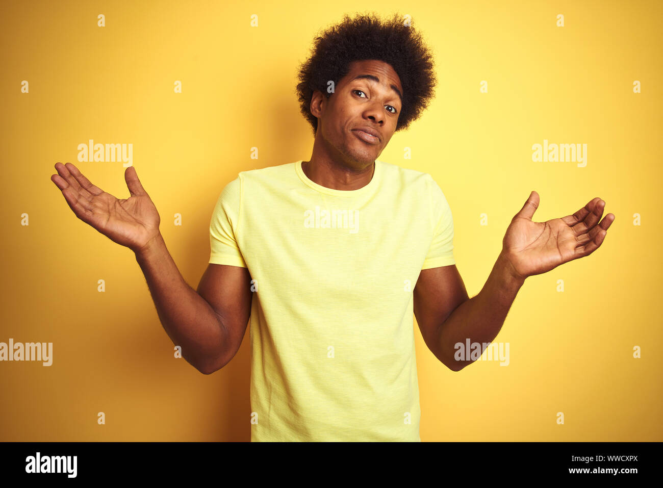 African american man with afro hair wearing t-shirt standing over ...