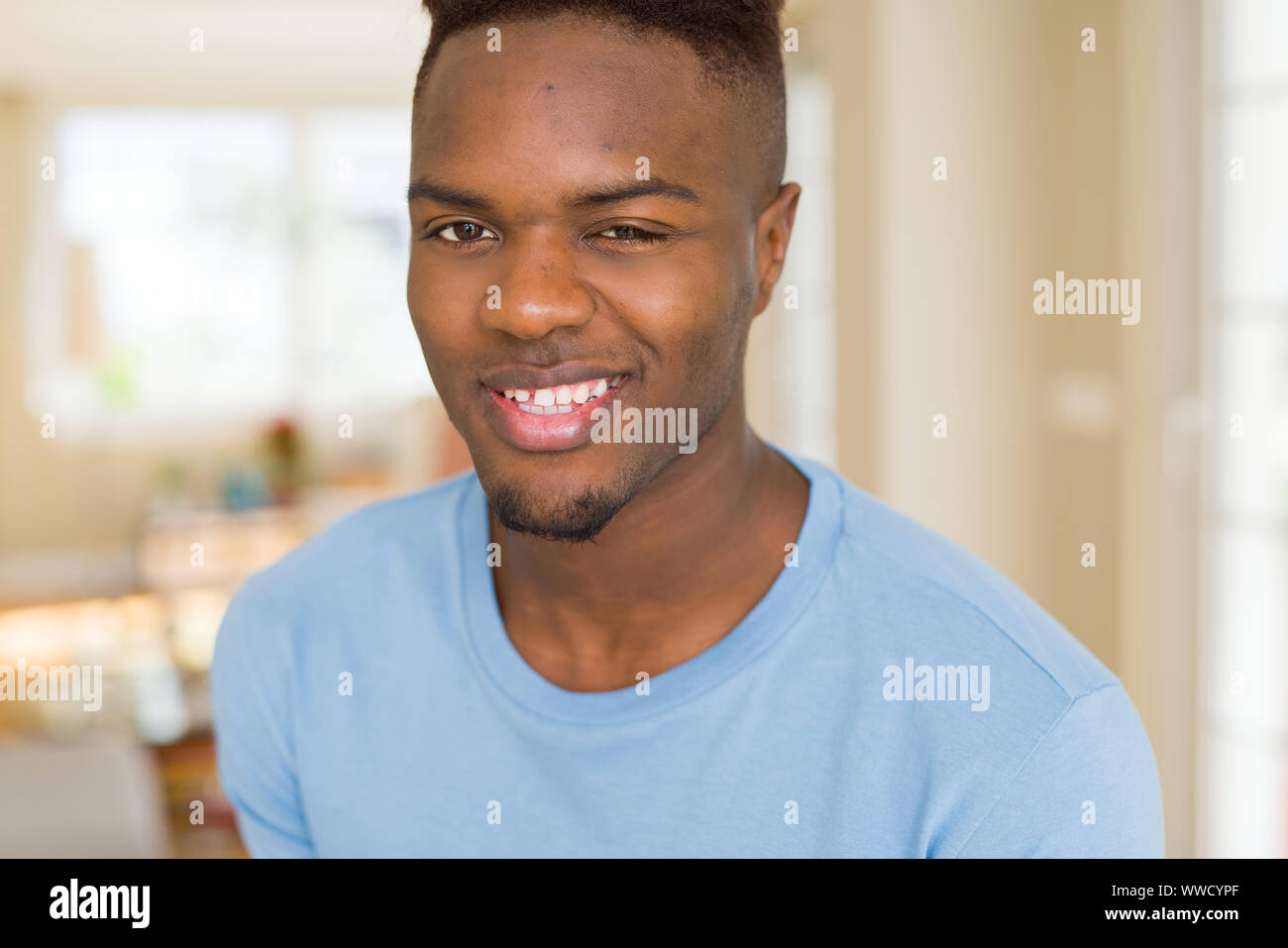 Handsome african young man smiling cheerful with a big smile on face ...