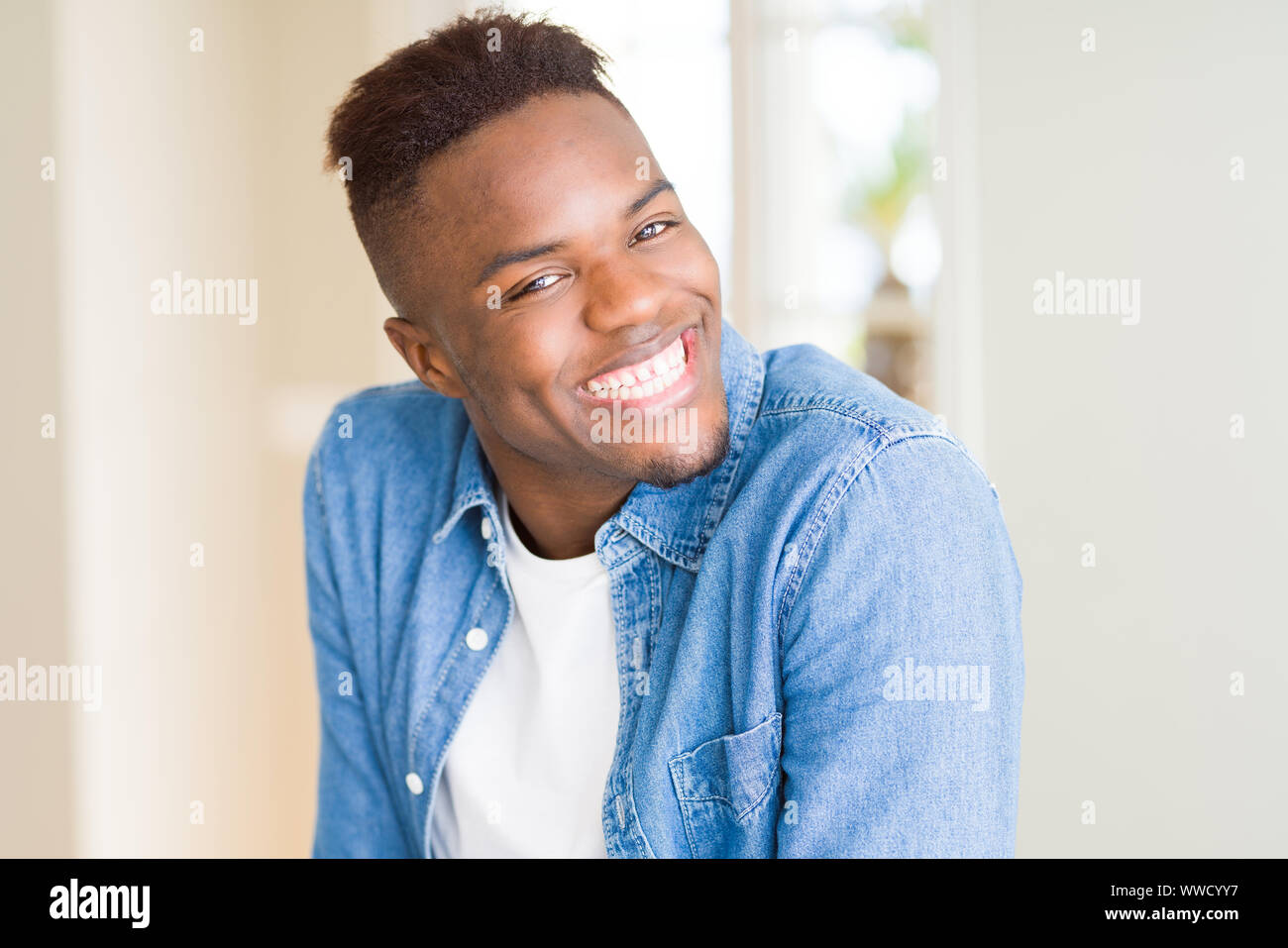 Handsome african young man smiling cheerful with a big smile on face ...