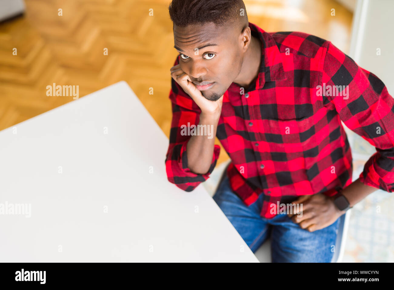 Overhead angle of handsome african american man thinking looking tired ...