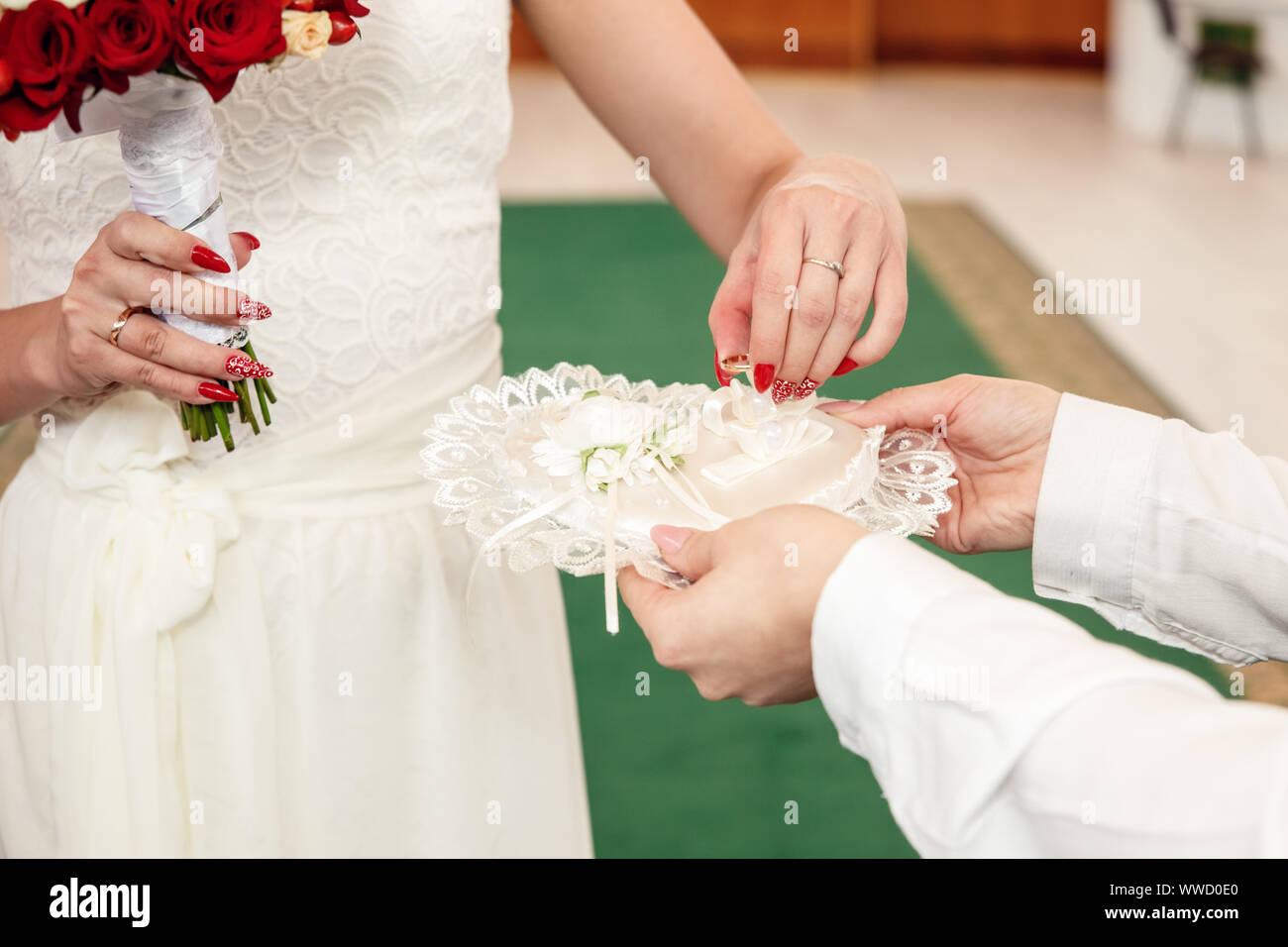 Young matrimonial pair, put on each other of weddings ring. Betrothed ...