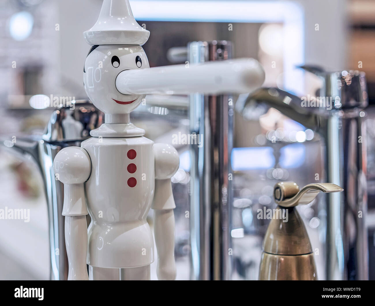 White water faucet in the form of Pinocchio Stock Photo - Alamy