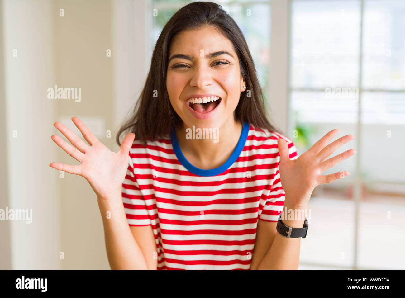 Beautiful young woman celebrating excited for success, screaming and ...