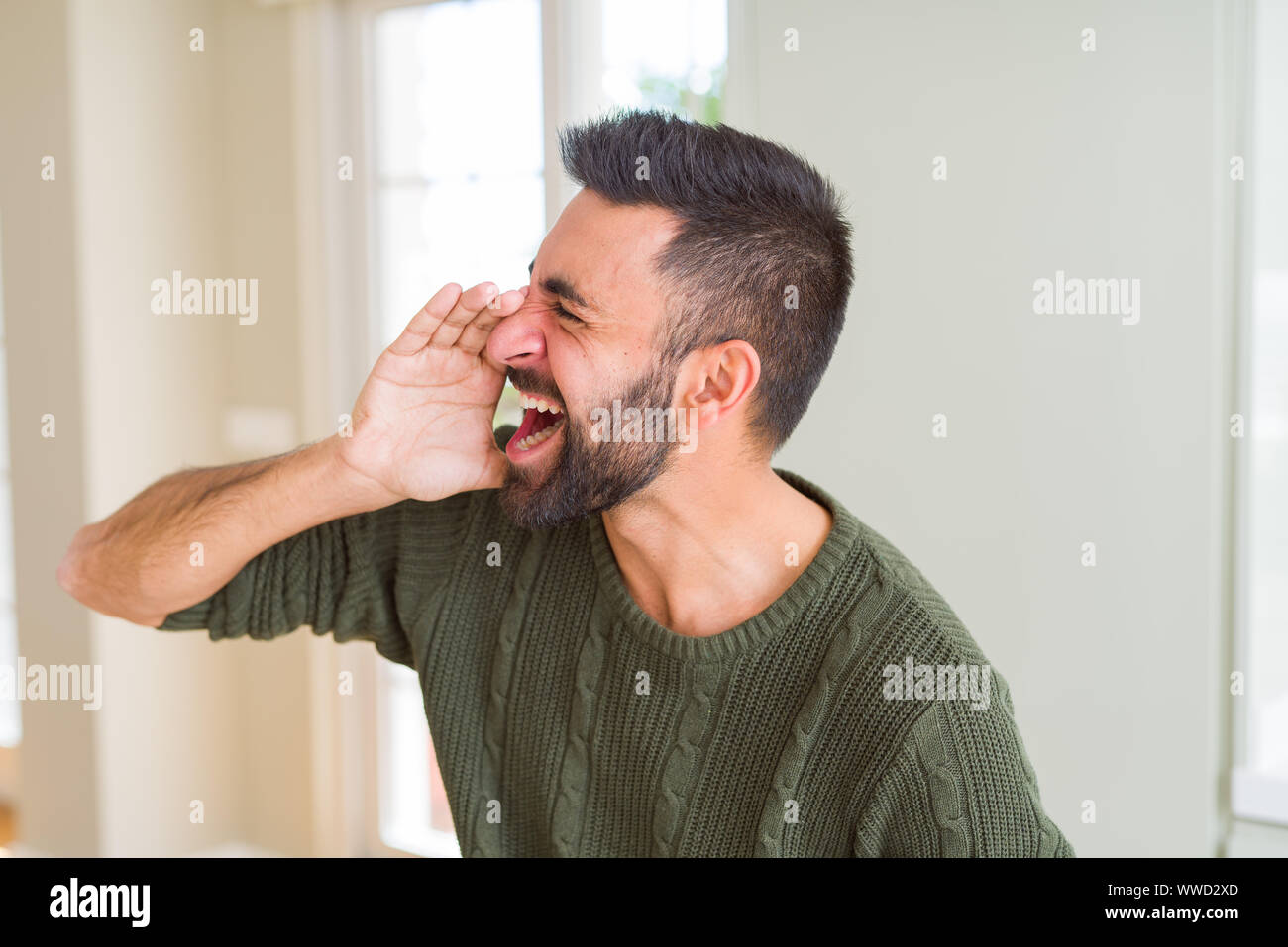 Man shouting with rage covering mouth with hands, yelling frustrated ...