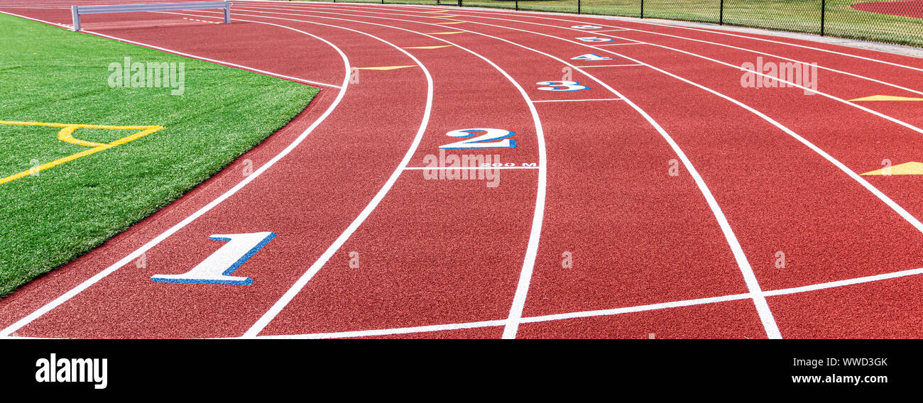 Landscape view of a red track with white numbers that have blue trim at ...
