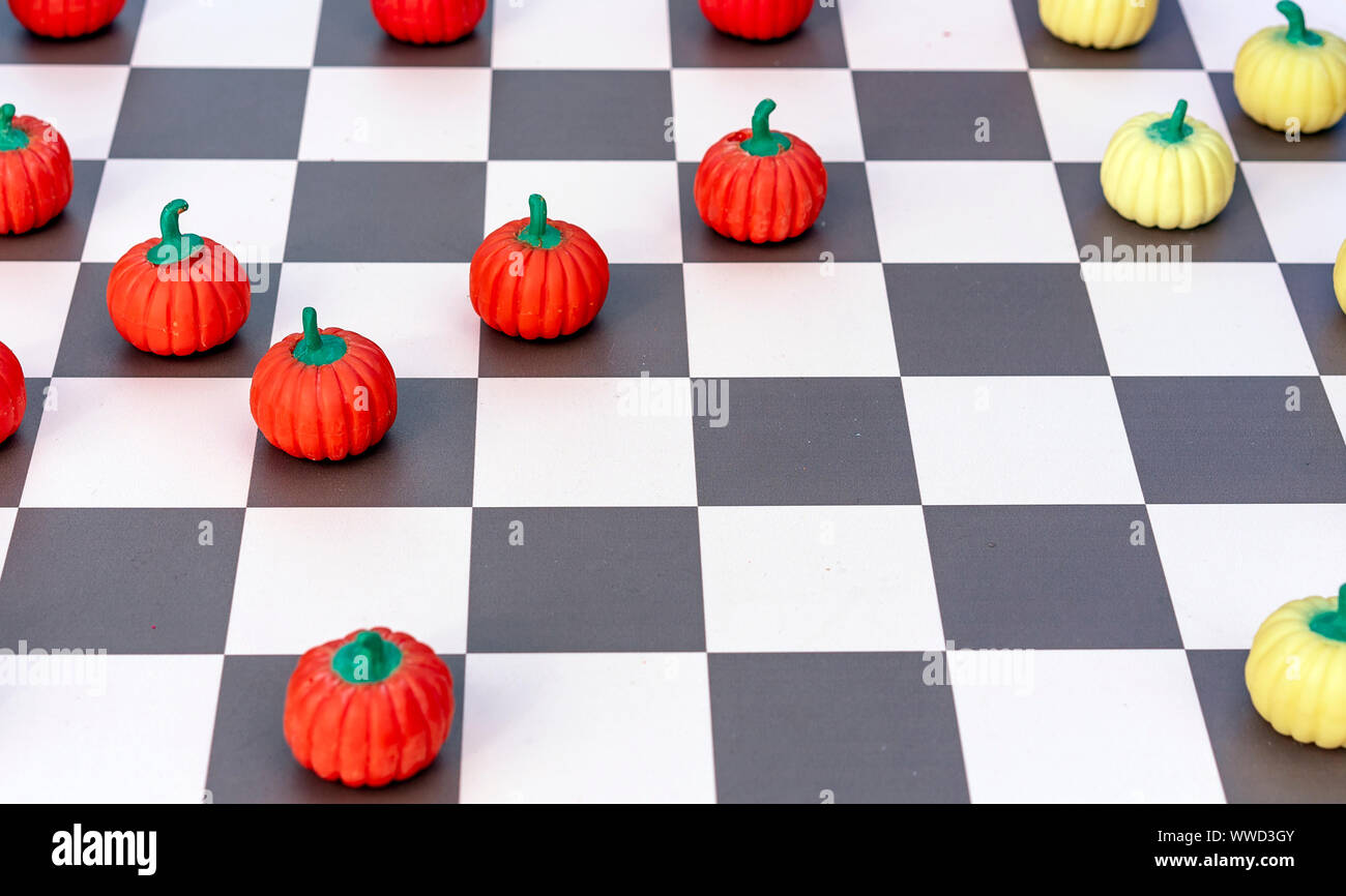 Game board with checkers in the form of orange and yellow pumpkins ...