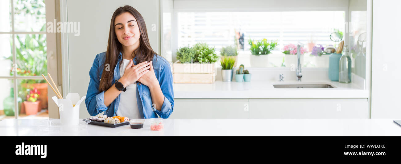 Wide angle picture of beautiful young woman eating delivery sushi ...