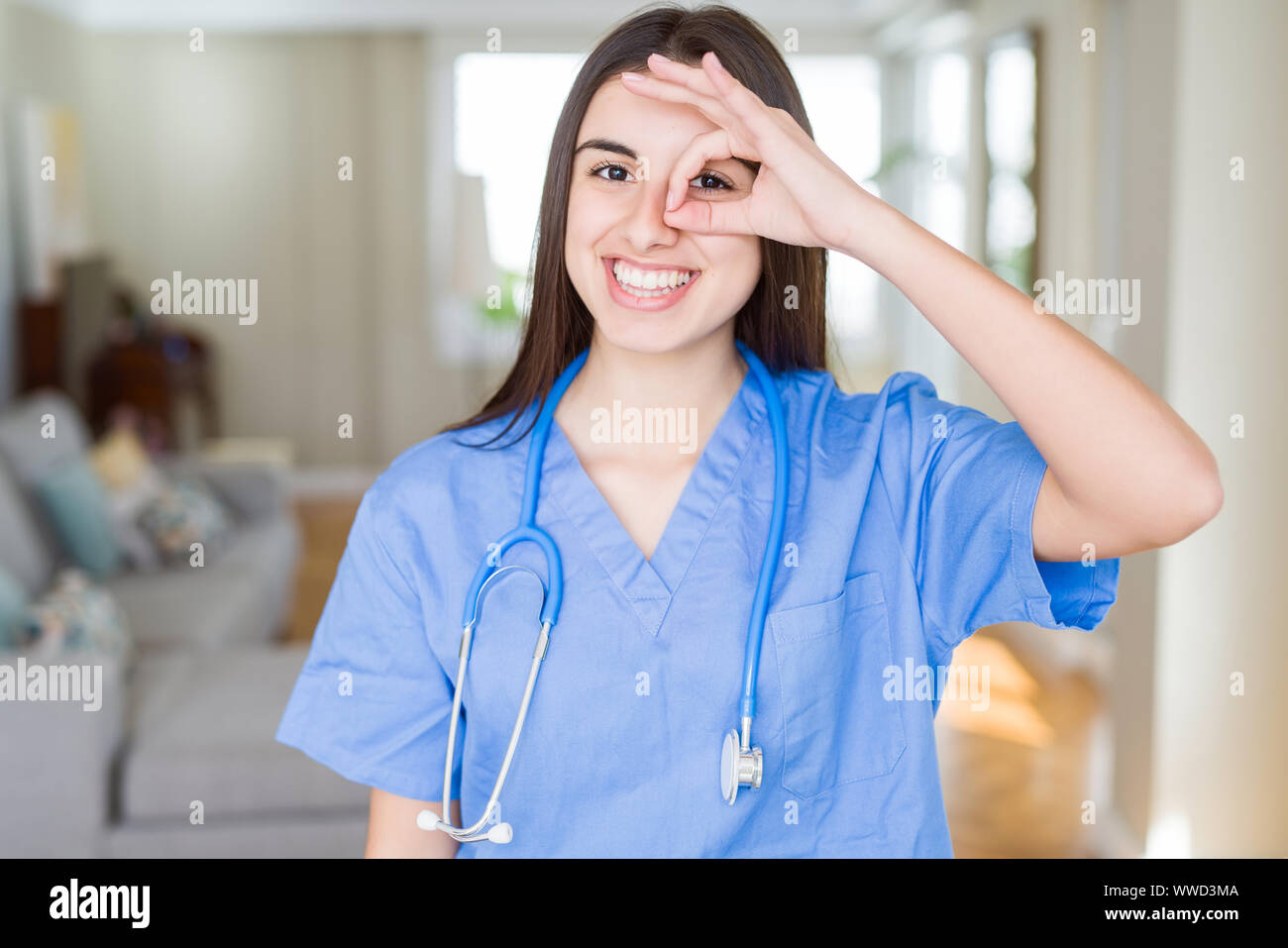 Beautiful young nurse woman wearing uniform and stethoscope at the ...