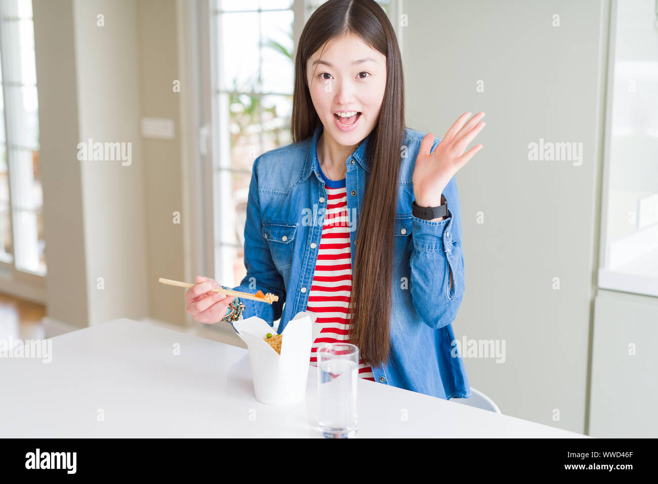 Beautiful Asian woman eating asian rice in delivery box very happy and ...