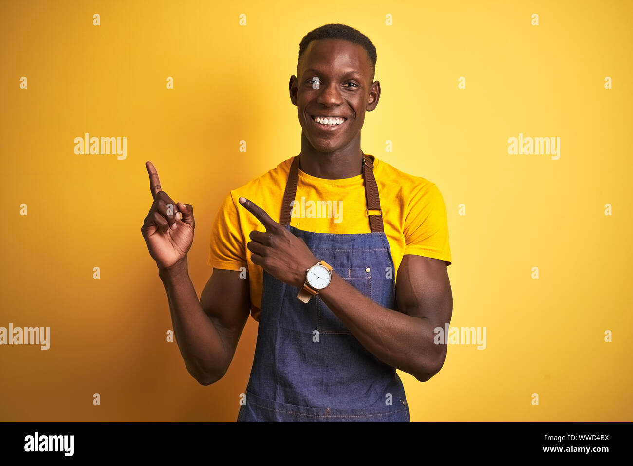 African american bartender man wearing apron standing over isolated ...