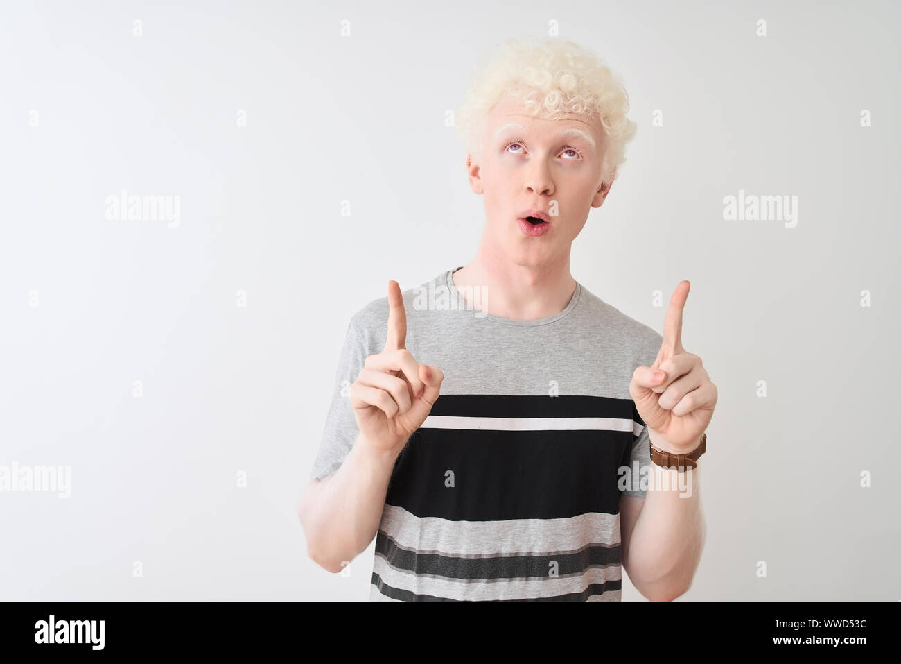 Young albino blond man wearing casual t-shirt standing over isolated ...