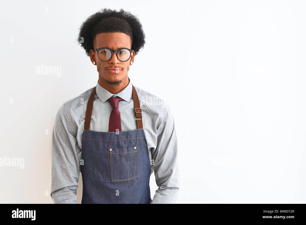 Young african american shopkeeper man wearing apron glasses over ...