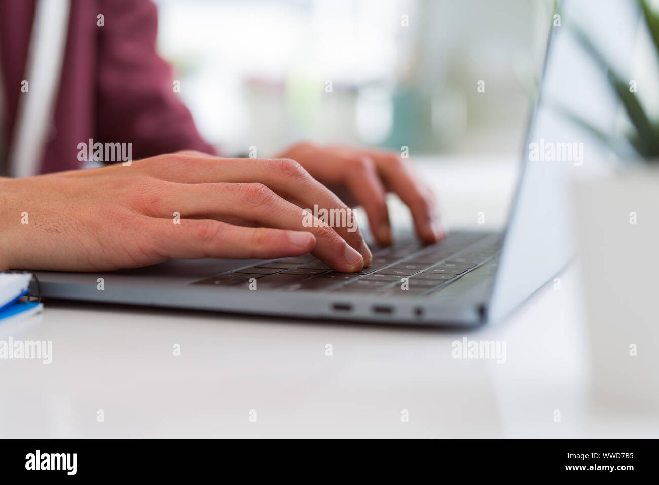 Close up of man hands using keyboard of computer laptop while working ...
