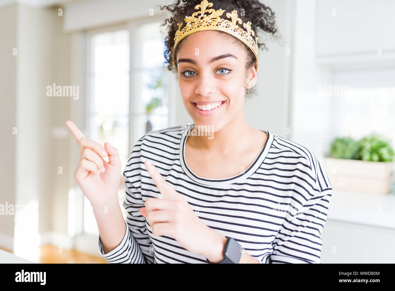 Young african american girl wearing golden queen crown on head smiling ...