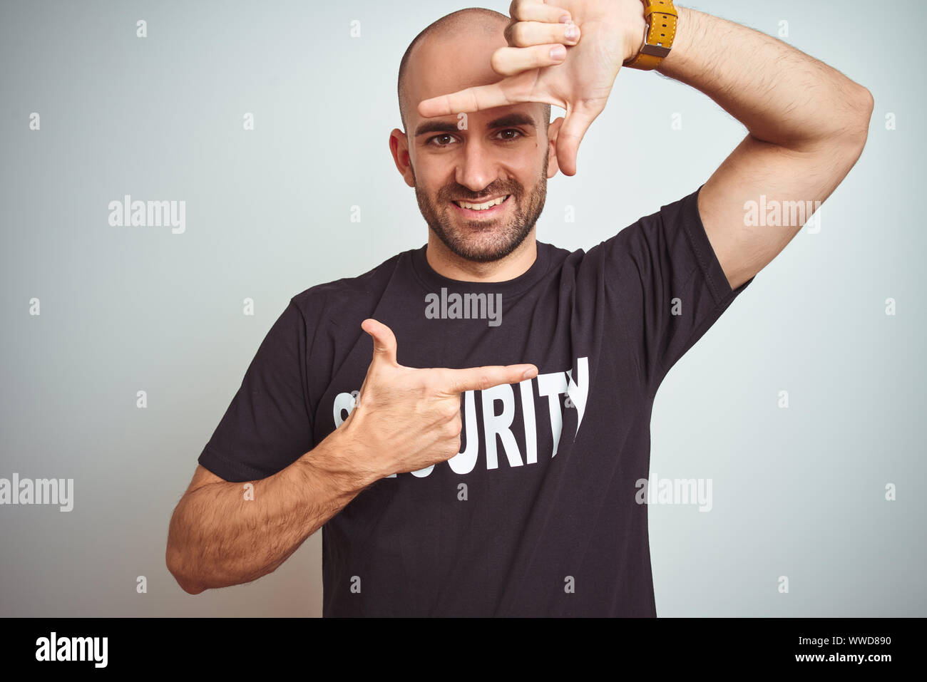 Young safeguard man wearing security uniform over isolated background ...