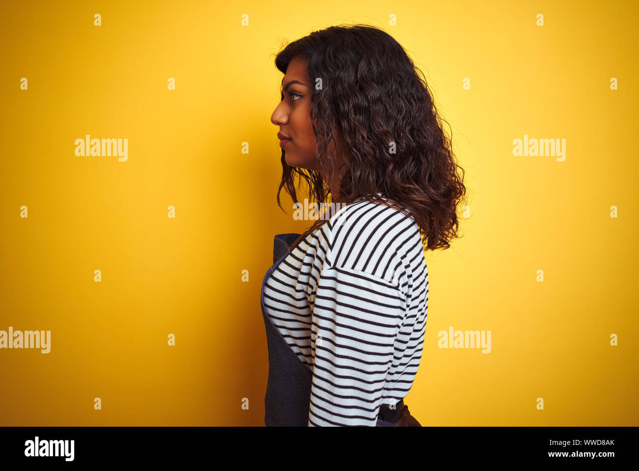 Young transsexual transgender chef woman wearing apron over isolated ...