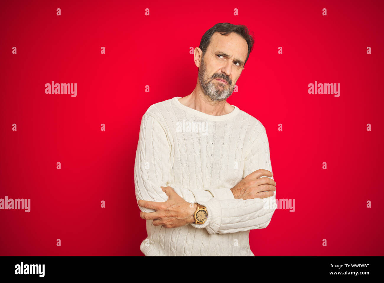 Handsome middle age senior man with grey hair over isolated red ...