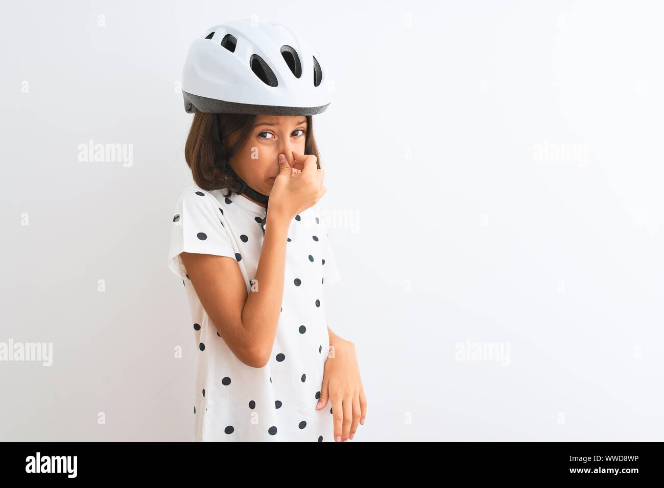 Beautiful child girl wearing security bike helmet standing over ...