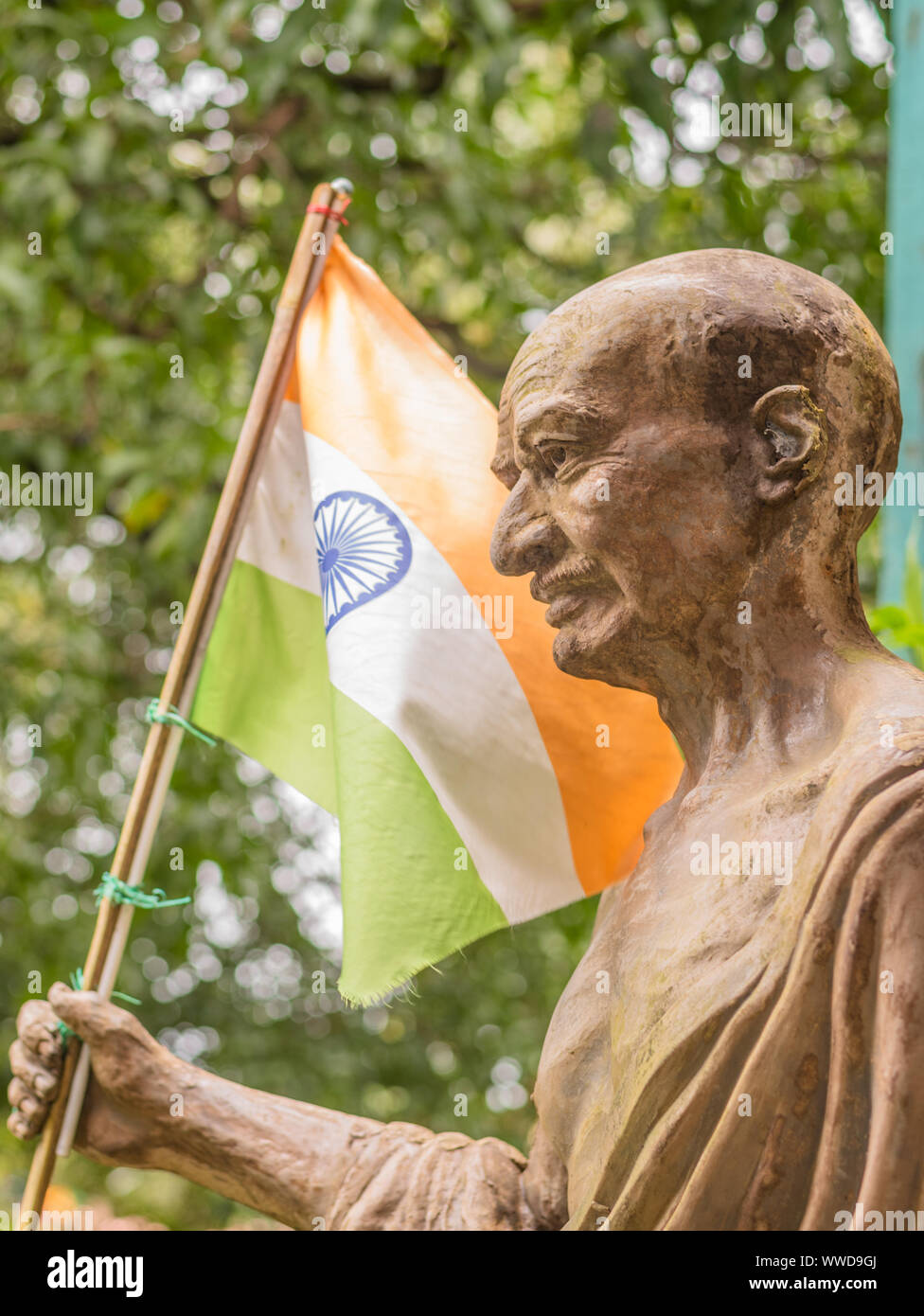 Status of Mahatma Gandhi holding the Indian flag in India on the ...