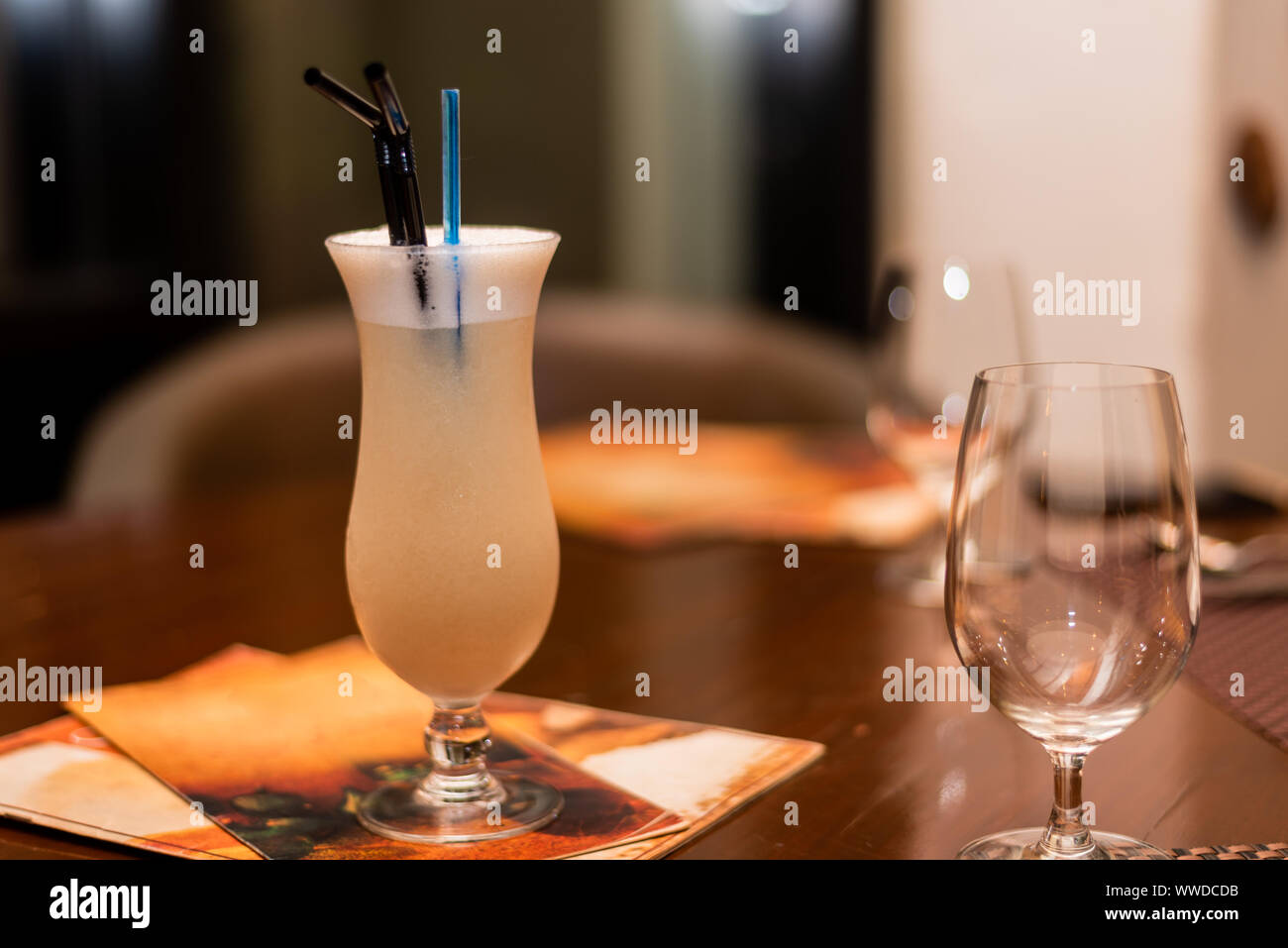 Interiors of restaurant with cocktail drink in focus and dish in ...