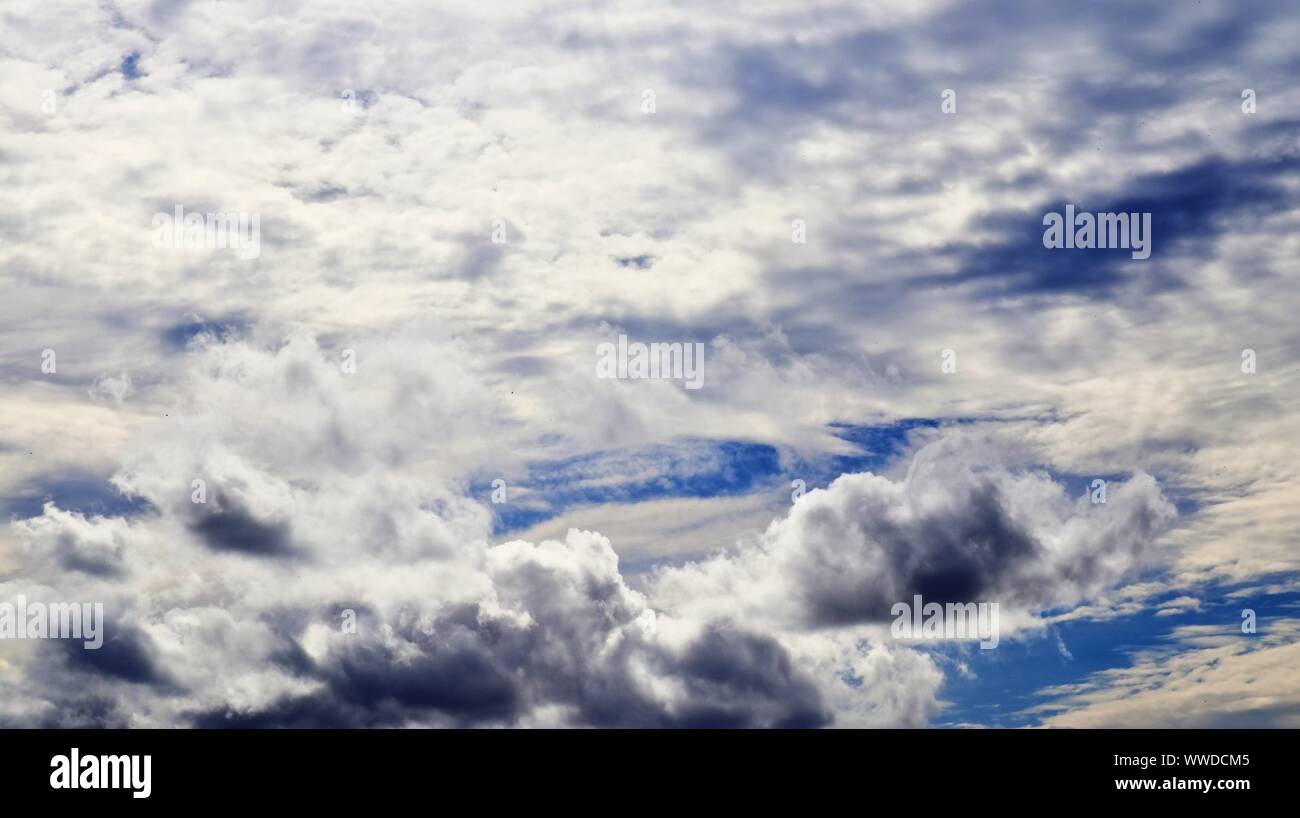 Stunning mixed cloud formation panorama on a deep blue summer sky Stock ...