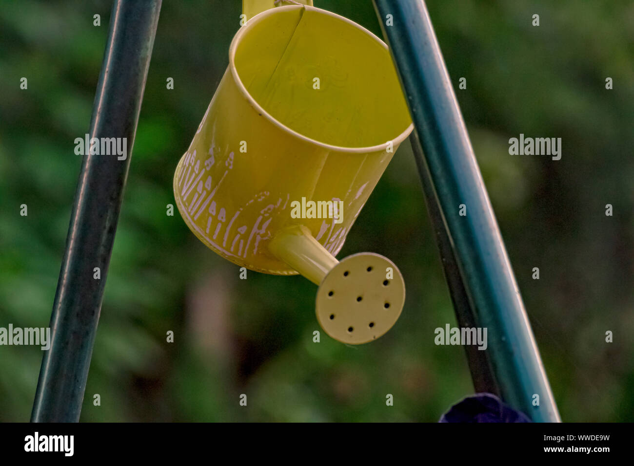 Yellow watering can made of metal Stock Photo - Alamy