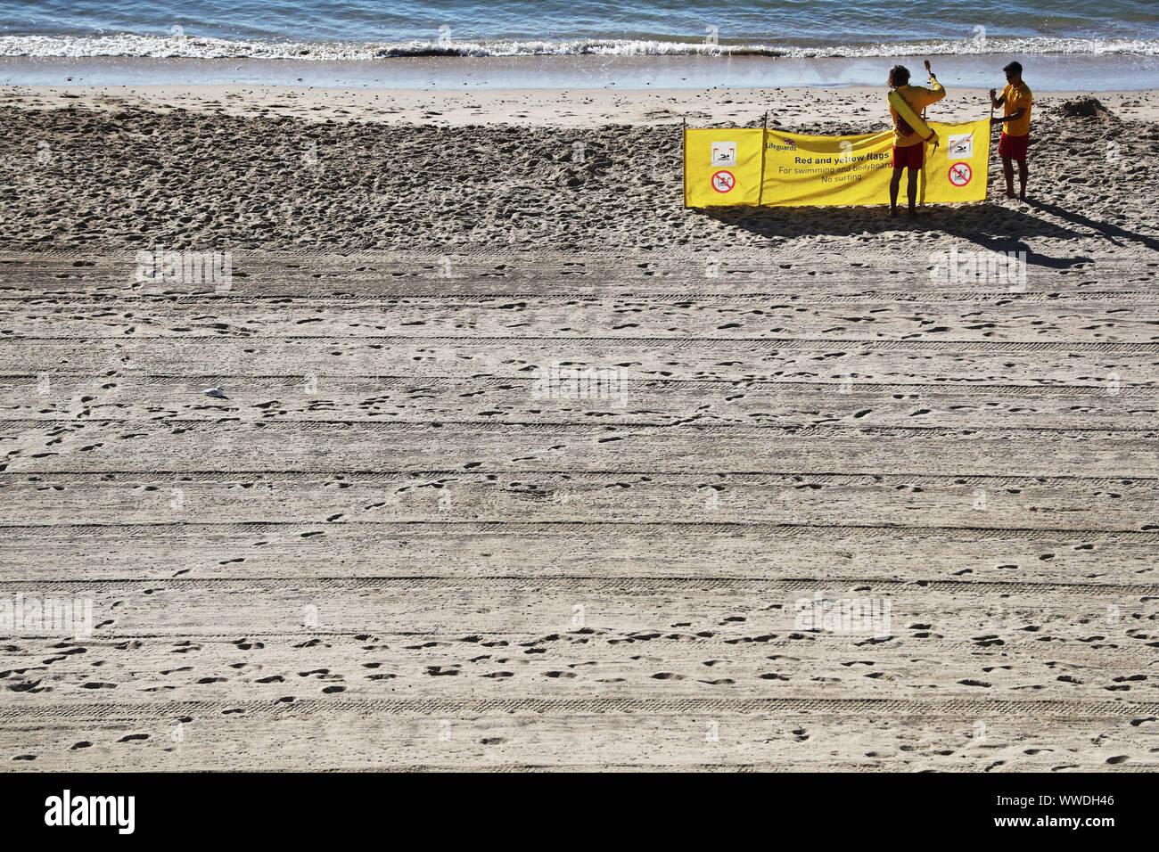 Lifeguards erect beach furniture on Bournemouth beach Stock Photo - Alamy