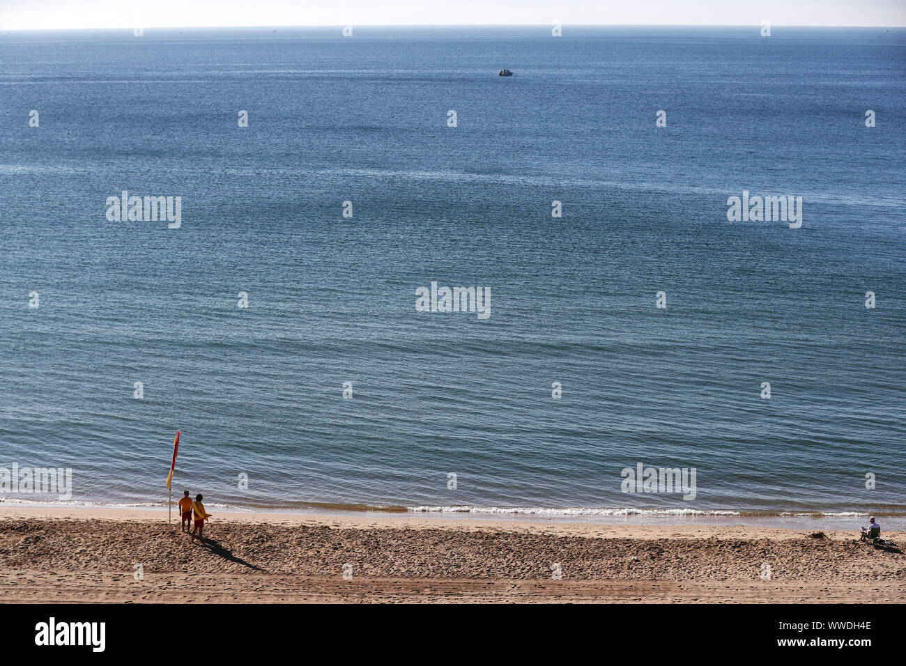 Lifeguards erect beach furniture on Bournemouth beach Stock Photo - Alamy