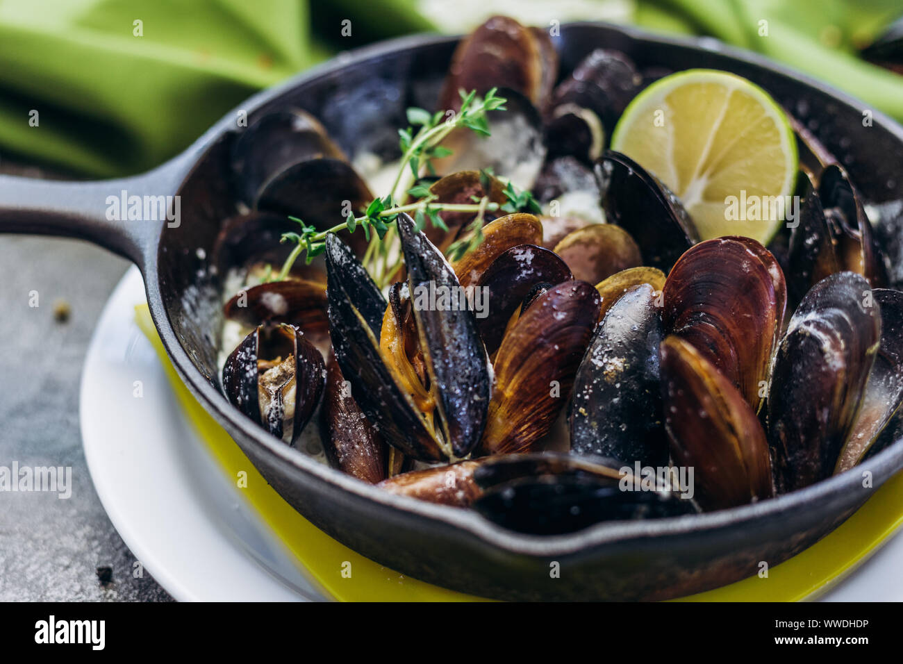 Baked Mediterranean mussels with creamy lime sauce Stock Photo - Alamy