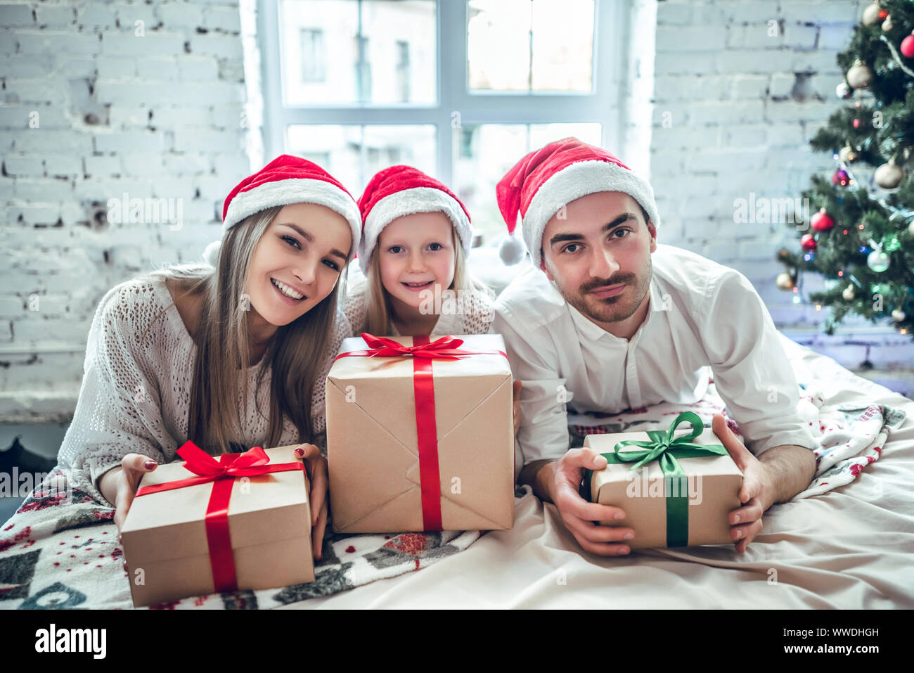 Cheerful parents with daughter celebrating new year Stock Photo - Alamy