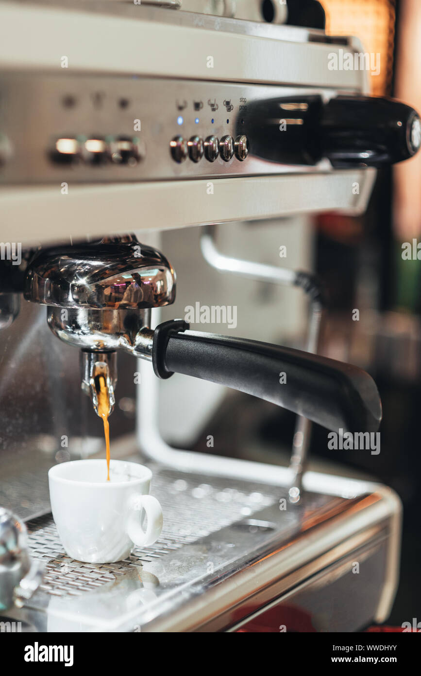 Close-up of espresso pouring from coffee machine. Professional coffee ...