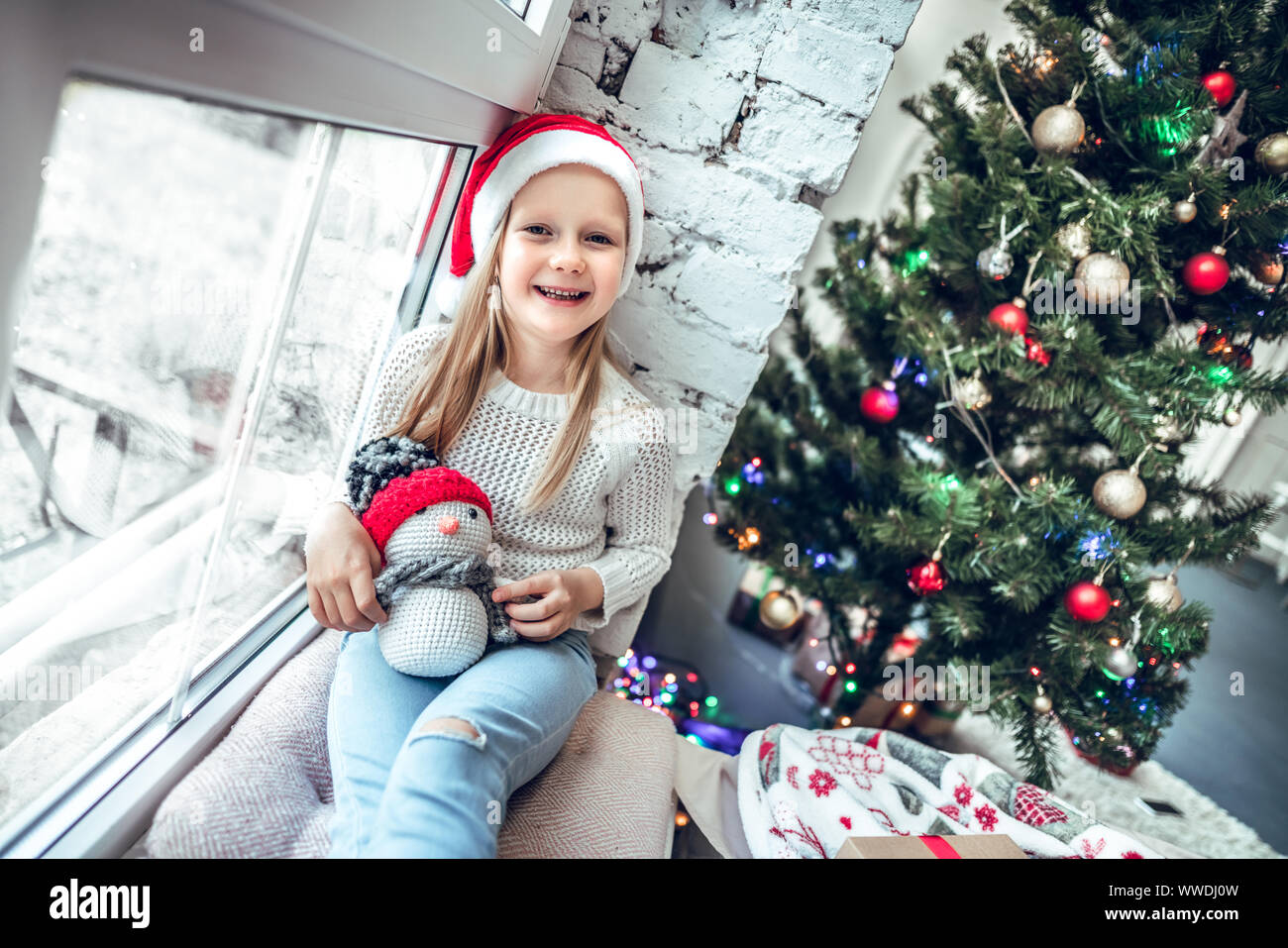 Girl sitting on santa claus hi-res stock photography and images - Alamy