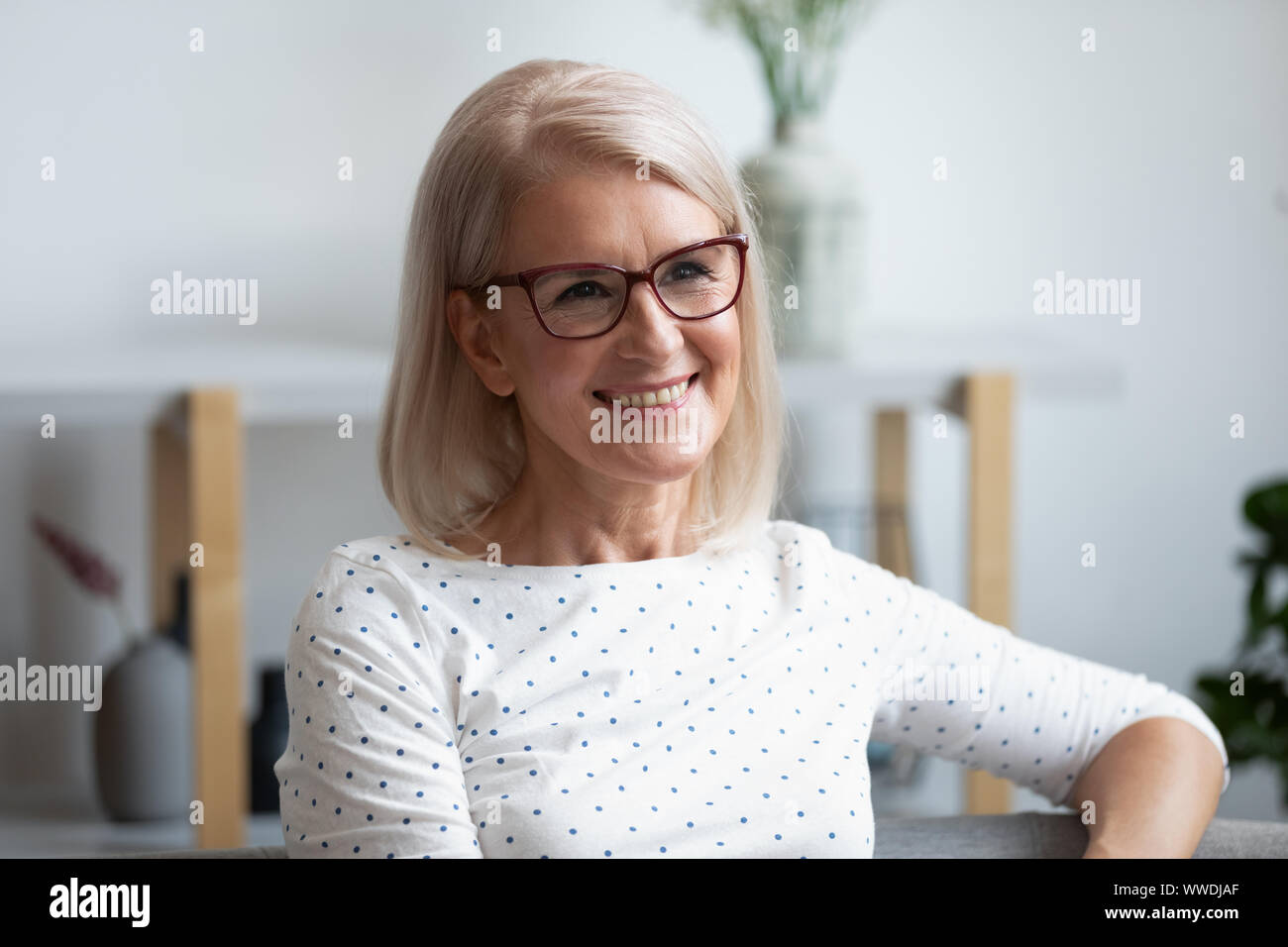 Head shot portrait smiling mature woman looking in distance Stock Photo ...