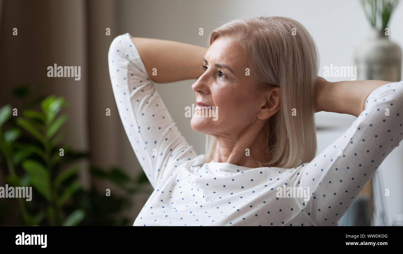 Dreamy mature woman relaxing leaning back, thinking about future Stock ...