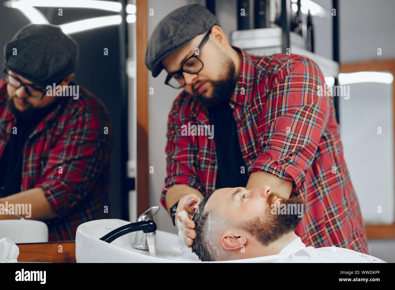 Hairdresser with a client. Man with a beard. Guy in a barbershop Stock ...
