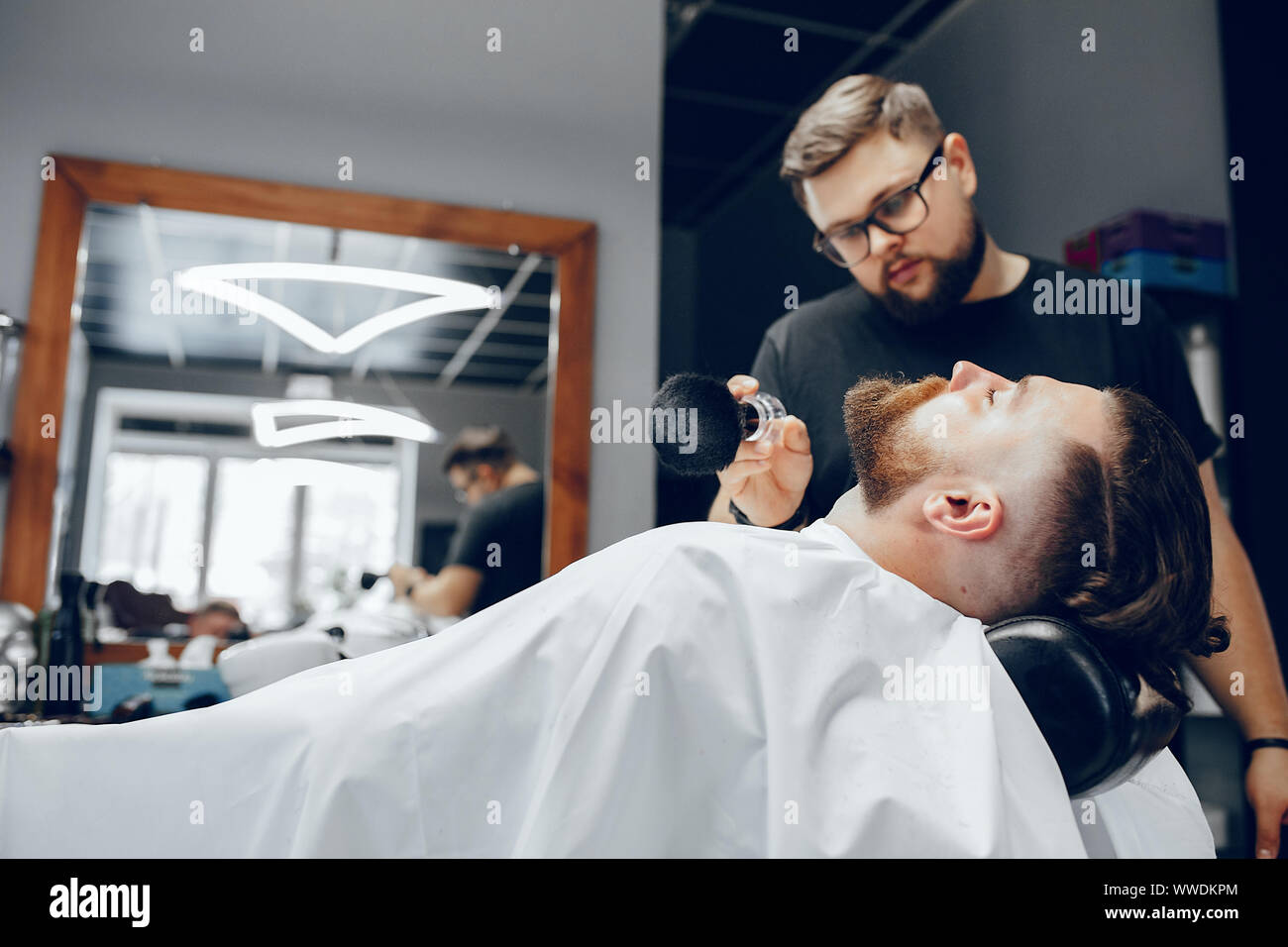 Hairdresser with a client. Man with a beard. Guy in a barbershop Stock ...