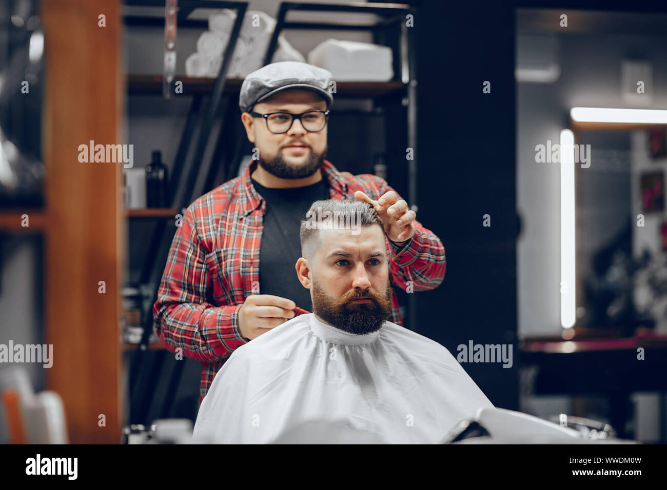 Man with a beard. Hairdresser with a client. Man in a red shirt Stock ...