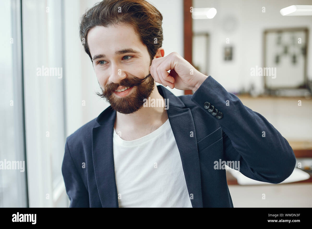 Man with a beard. Guy standing in a barbershop Stock Photo - Alamy