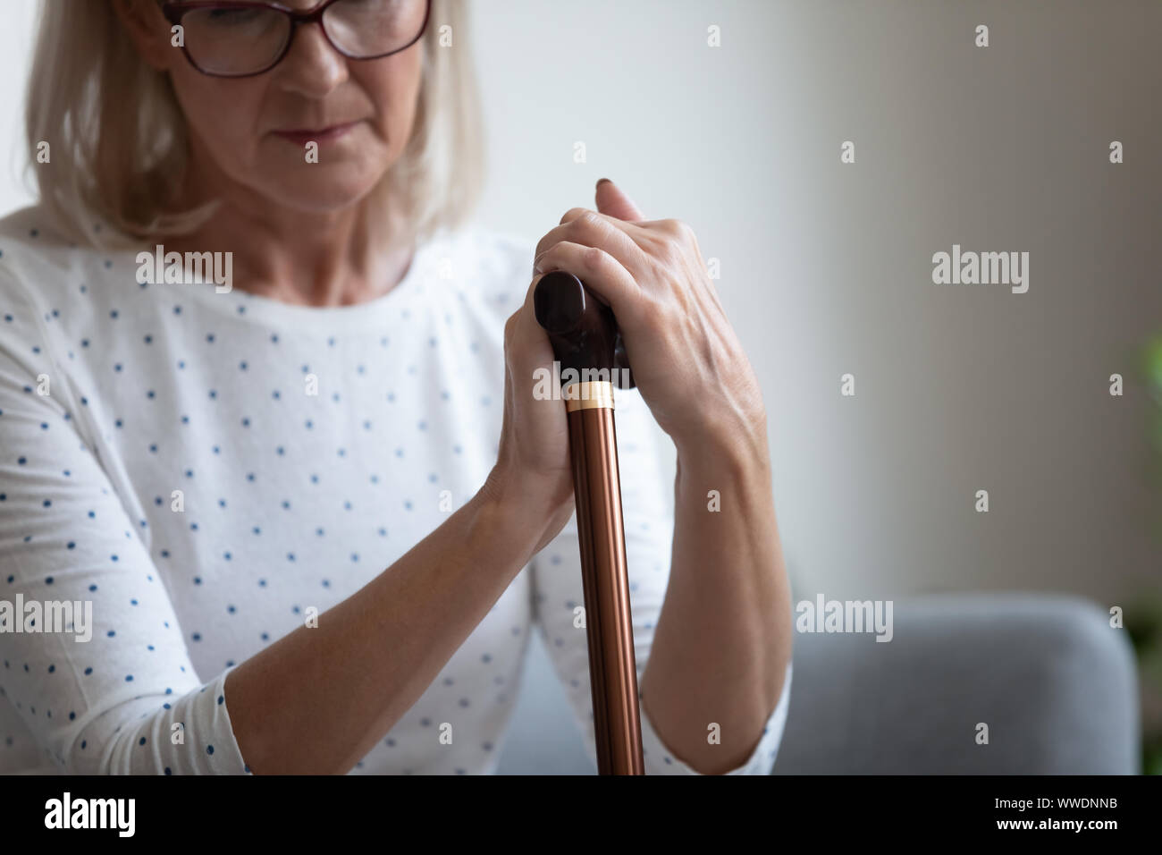 Woman with walking stick hi-res stock photography and images - Alamy