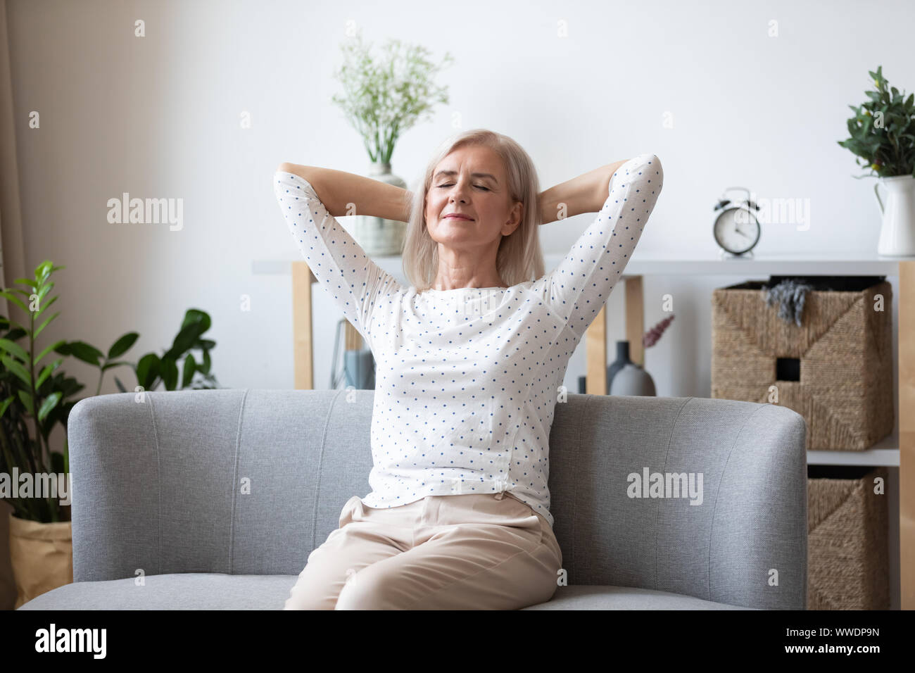 Woman relax couch indoor mature hi-res stock photography and images - Alamy